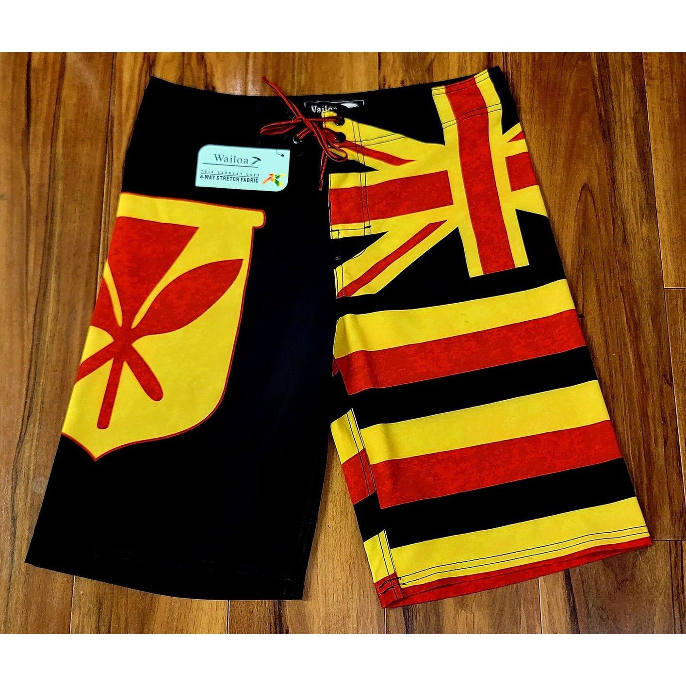 Wailoa “Red/Yellow Kanaka Symbol” Board Shorts — Leilanis Attic